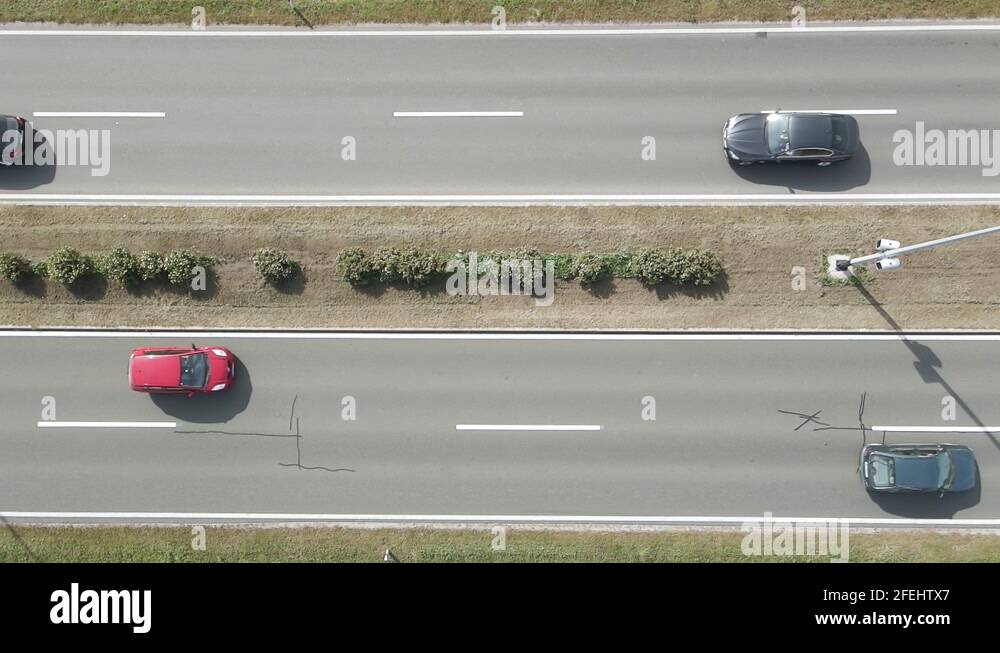 Cars running in opposite direction on the 4 lane highway on bright ...