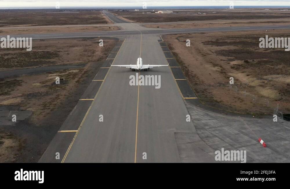 Back view of private jet taxiing on flight line towards airstrip for ...