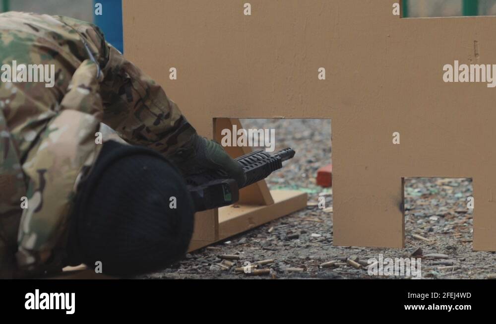 Man Laying on the Ground Shooting AR 15 Rifle from Prone Position Stock ...