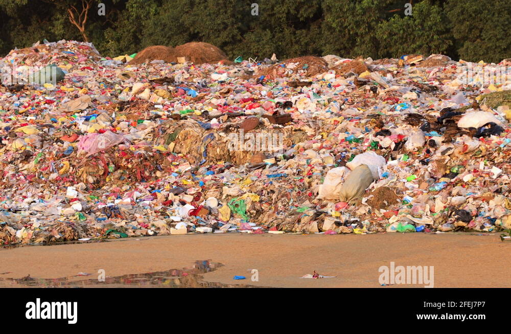 Garbage Landfill near polluted river. Water pollution and environmental ...