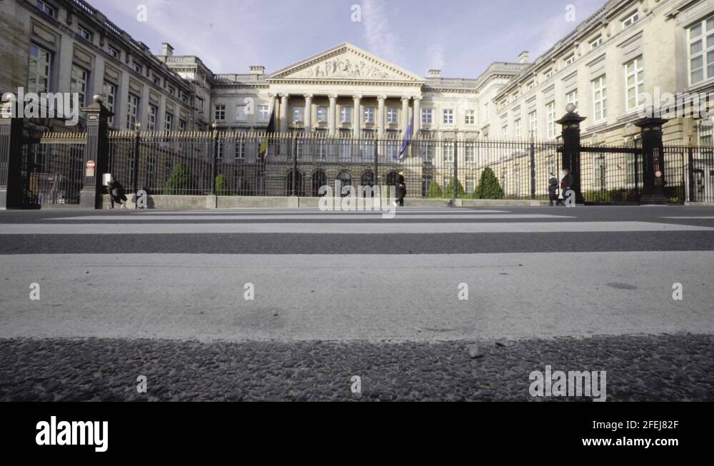 Low wide angle shot from a crosswalk, pedestrians and traffic in front ...