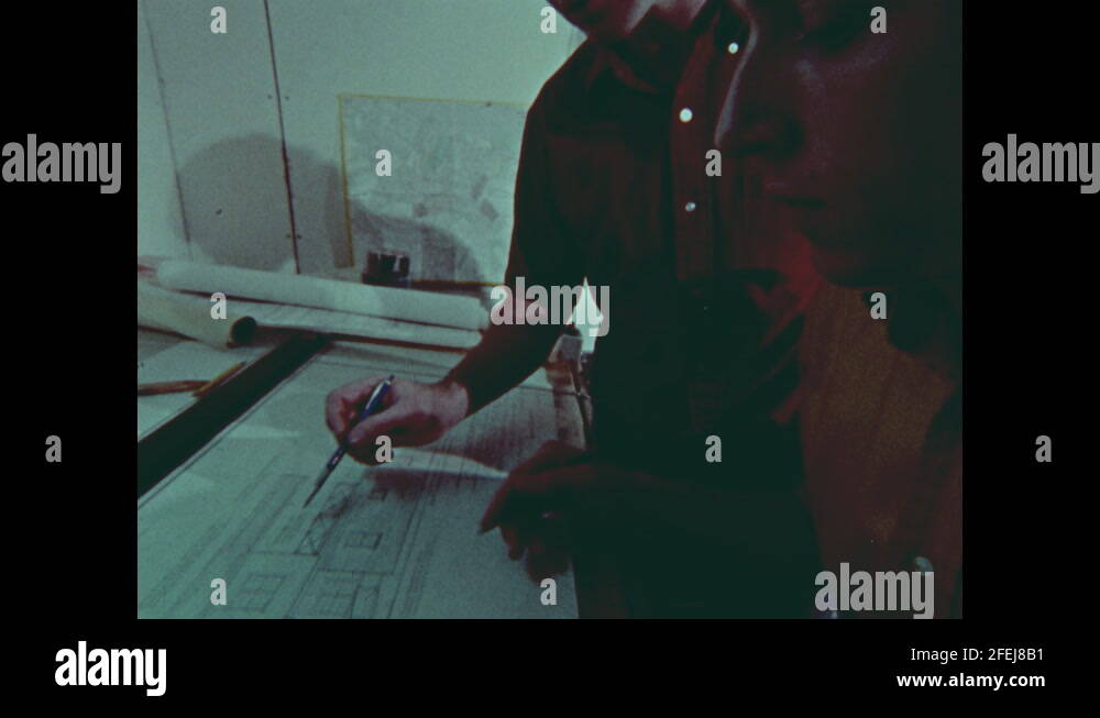 1970s: Men stand at drafting table, look at blueprints. Man talks Stock ...