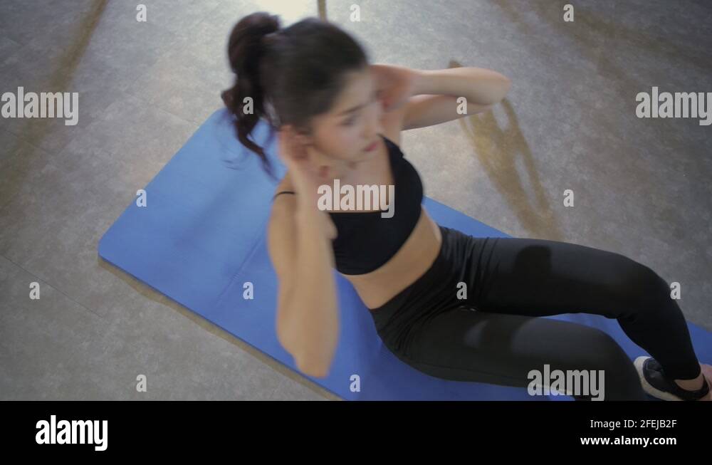 Fitness concept. Asian female athletes sit-ups at the gym. 4k ...