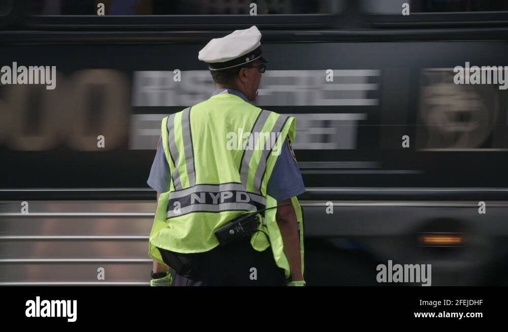 NYPD traffic police officer doing traffic in very busy midtown street ...