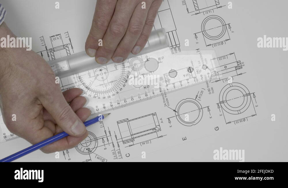 An engineer makes a drawing of the mechanism using a transparent roller ...