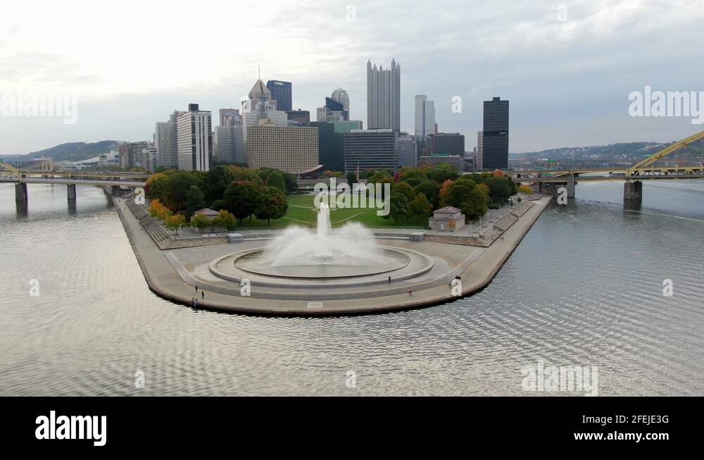 Pittsburgh PA skyline as seen from drone above river. Point State Park ...