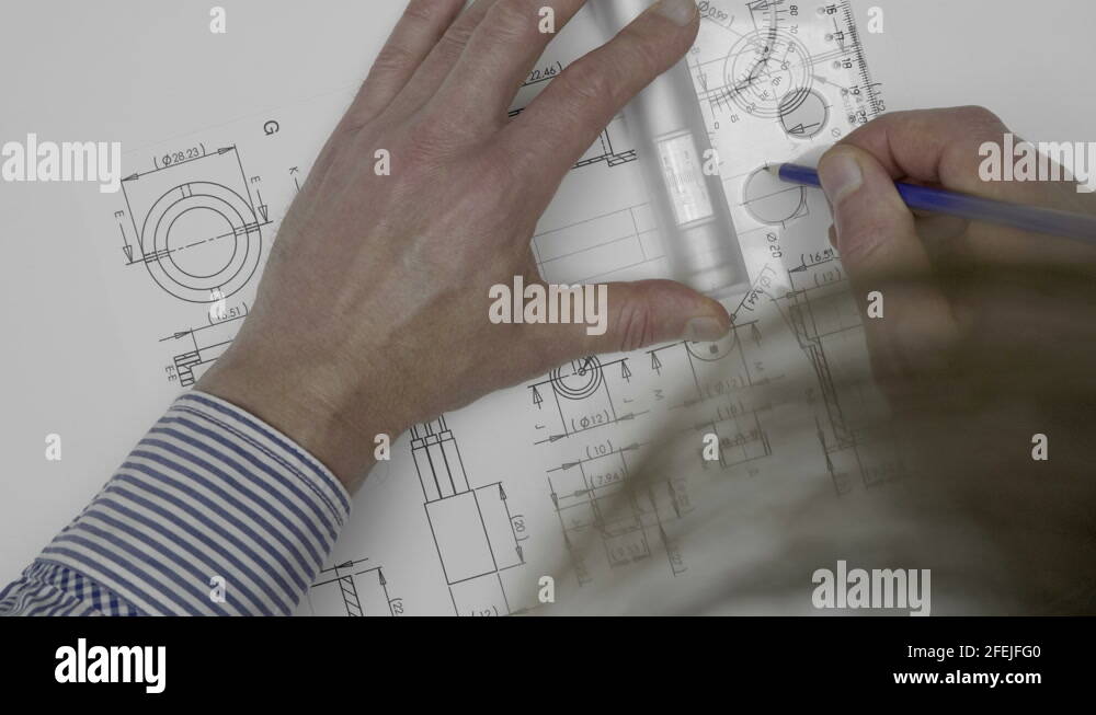 An engineer makes a drawing of the mechanism using a transparent roller ...