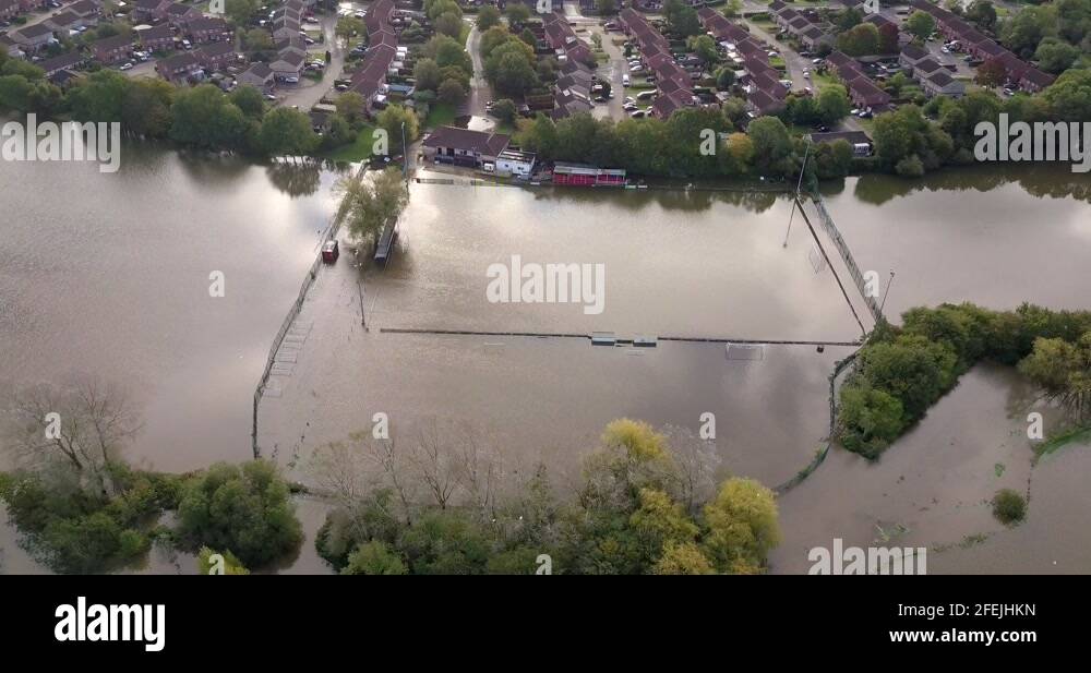 Drone footage of flooded football pitch. Sky and clouds reflecting in ...