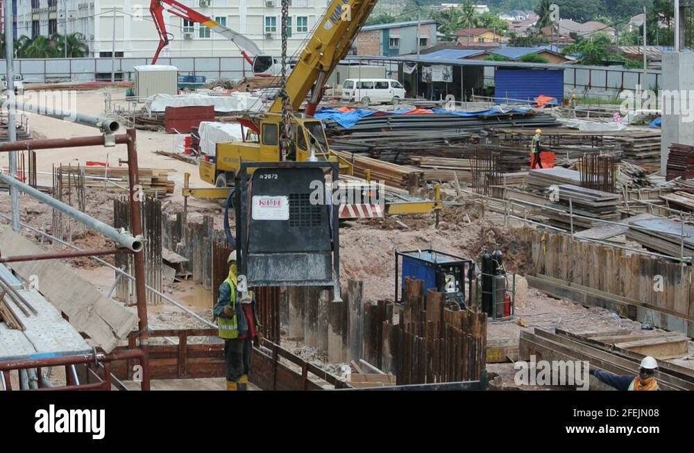 Mobile crane lifting small generator set from a lorry at the ...