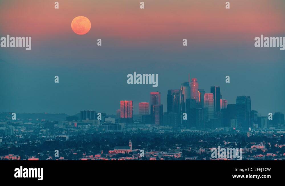 Full moon rising above downtown Los Angeles skyline background. 4K UHD ...