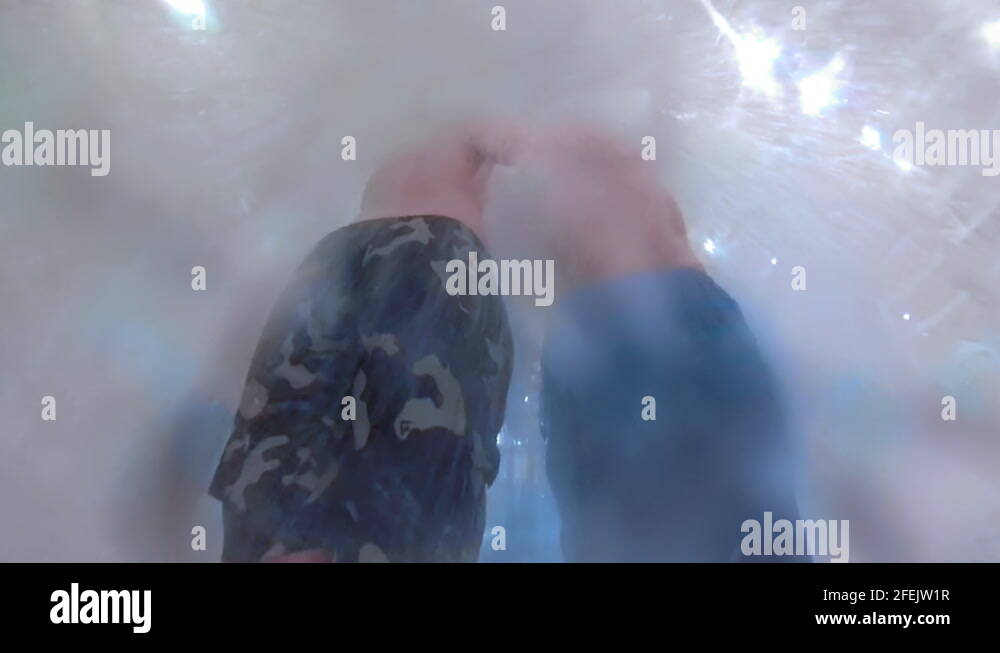 Two kids getting water dumped on them at a water park Stock Video ...