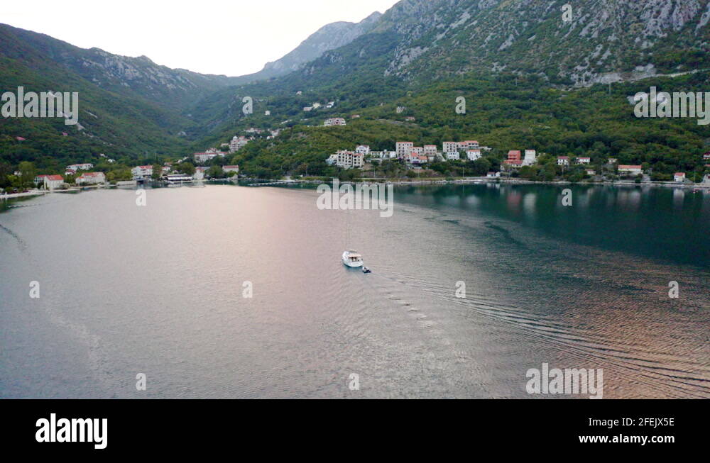 A luxurious white yacht with a tall mast without sails towing an empty ... A luxurious white yacht with a tall mast without sails towing an empty ...