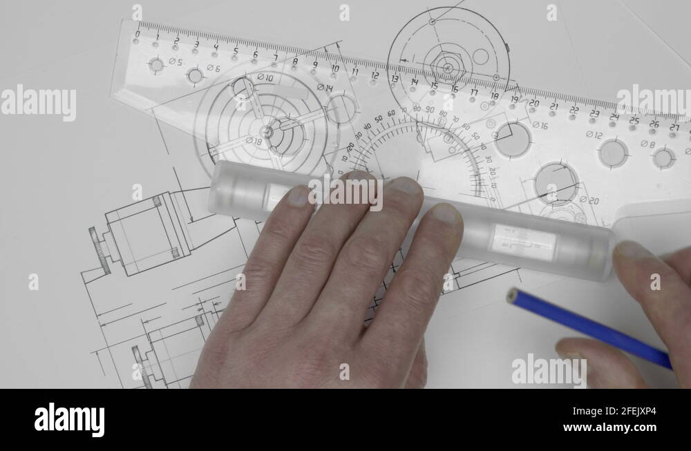 An engineer makes a drawing of the mechanism using a transparent roller ...