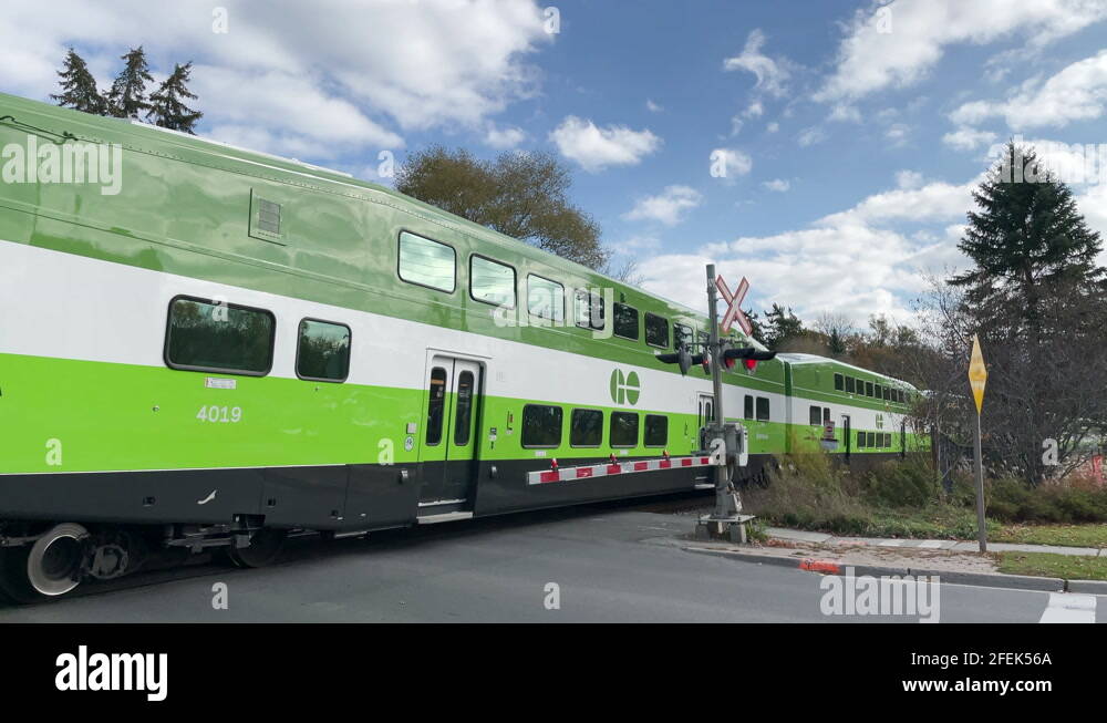 Go train passing at railroad crossing Stock Video Footage - Alamy