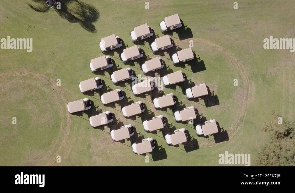 Symmetrical, group formation of golf carts, top down rotating aerial ... Symmetrical, group formation of golf carts, top down rotating aerial ...