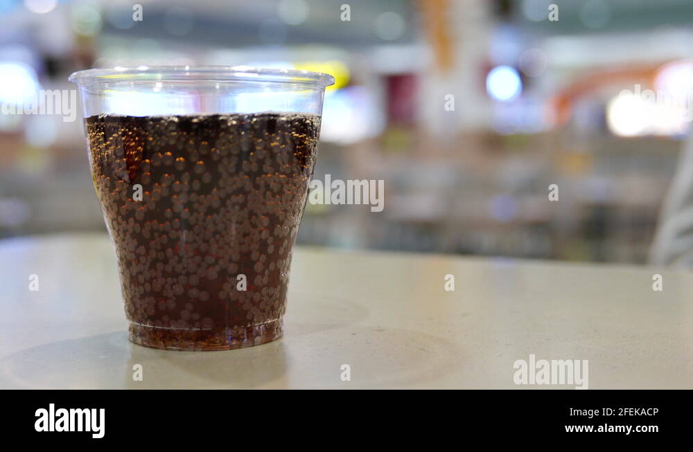 A cup of coca cola on table inside shopping mall with 4k resolution ...