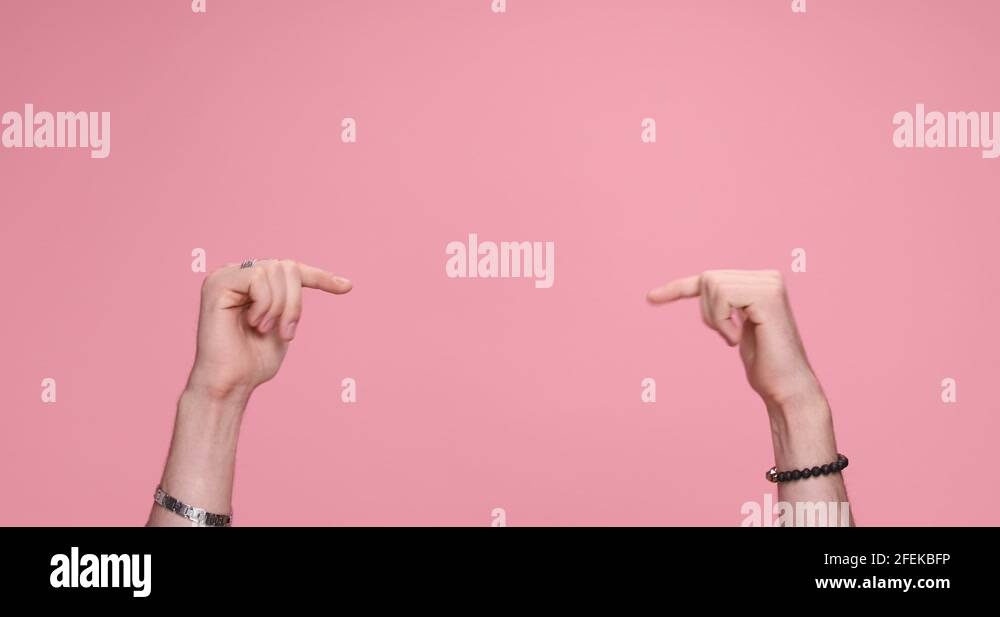 two hands pointing up, at each other, giving a thumbs up on pink ...