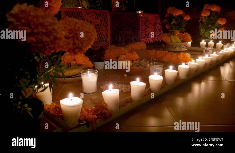 A traditional altar with flowers and candles used as an offering for ...