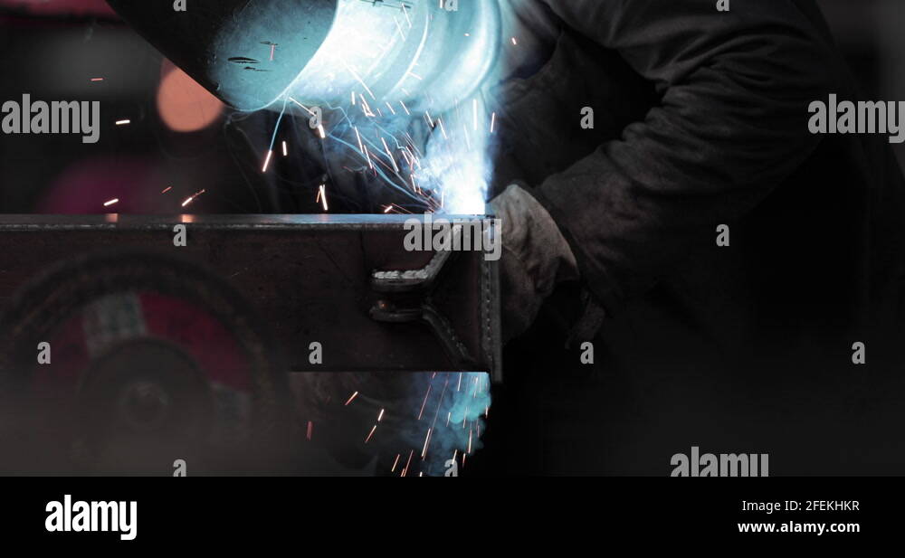 Welder Welding Joint Of A Metal Bar In A Steel Factory - close up, slow ...