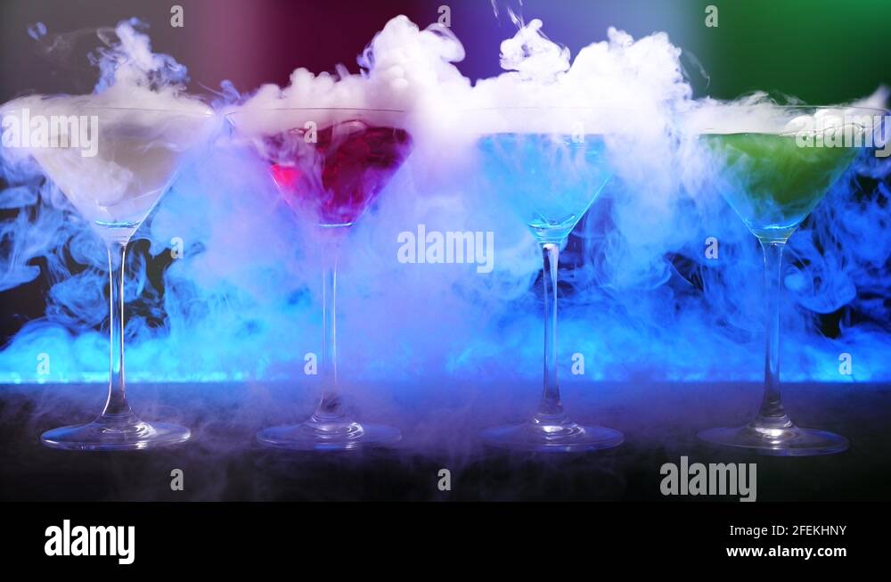 Colorful cocktails with dry ice smoke effect at bar counter. Bartender ...