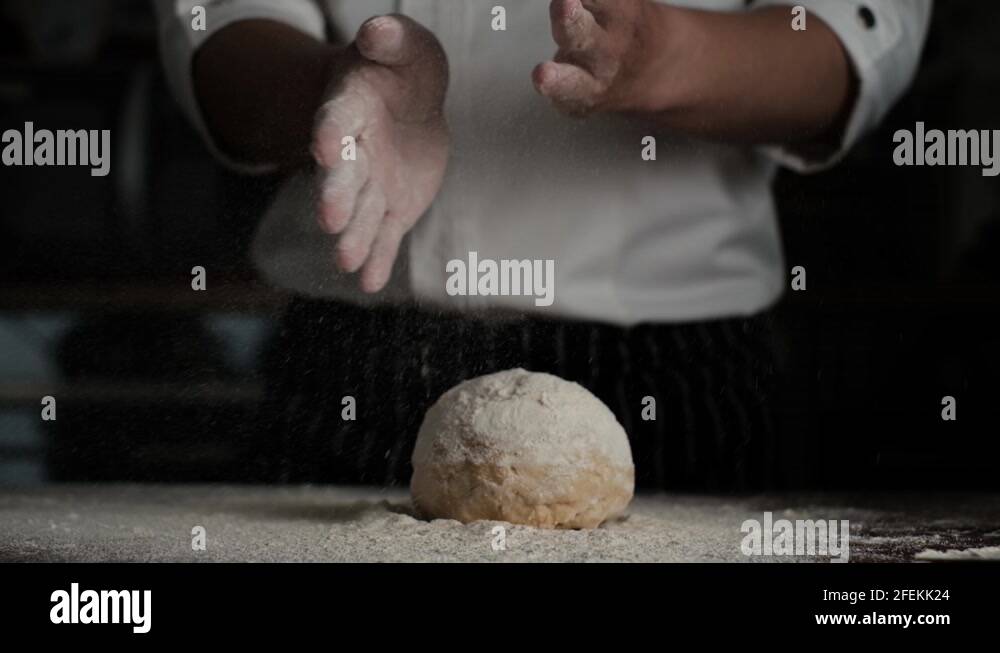 bakery chef clapping flour making bread dough. Baking concept Stock ...
