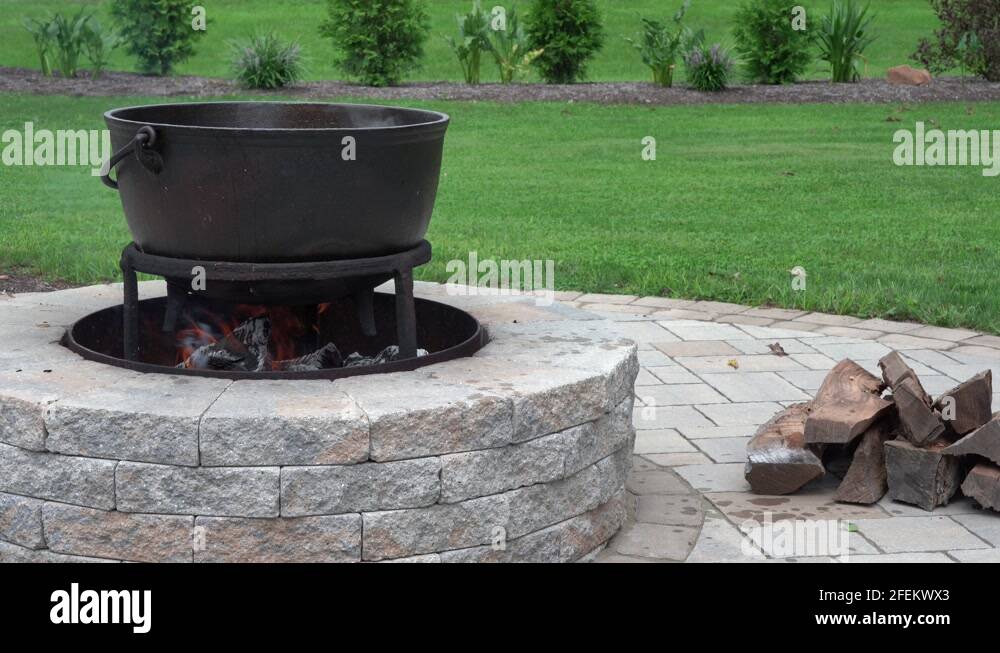 An old fashioned iron kettle over the fire of an outdoor campfire Stock ...
