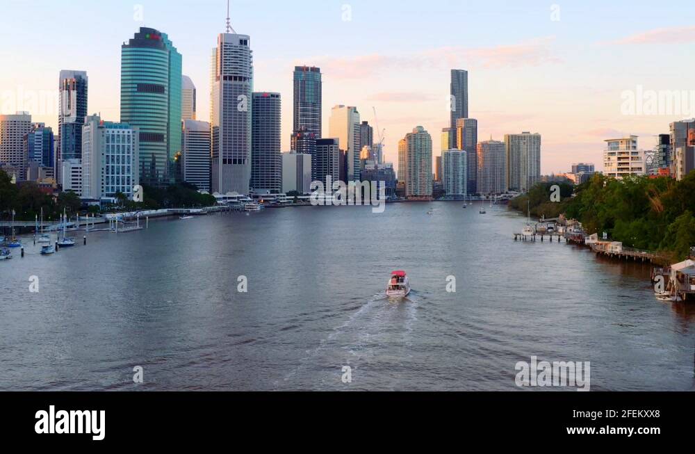 Motorboat Sailing At Brisbane River Overlooking The High-rise Buildings ...