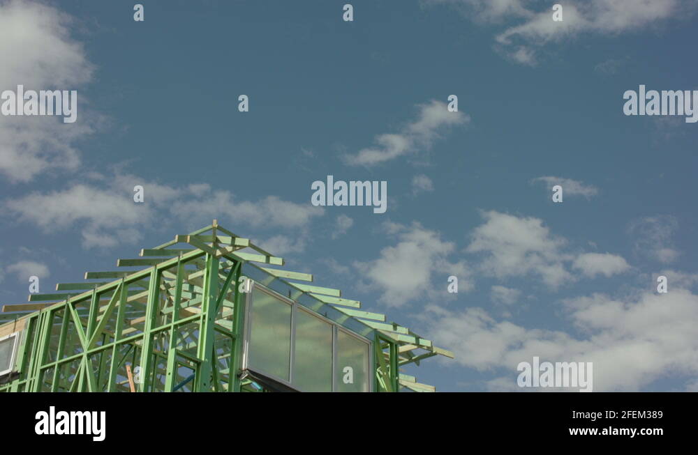Tilt down from sky onto second story house frame in the suburbs Stock ...