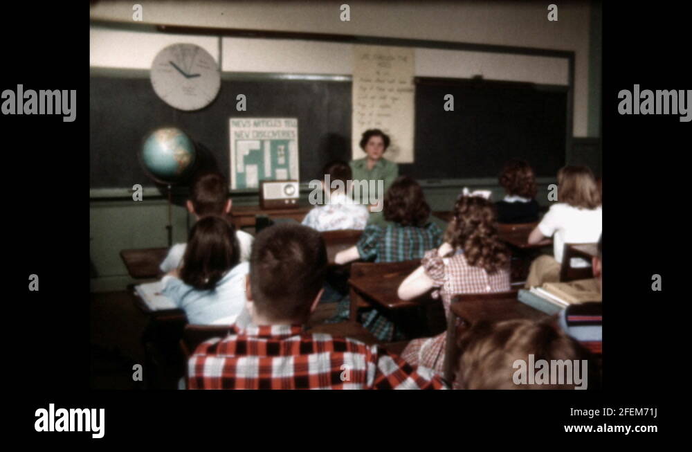 1960s: Teacher sits at front of classroom with radio, students sit at ...