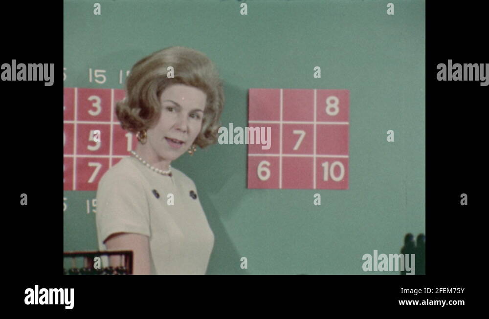 1960s: Teacher speaks and points to numbers and boxes. Teacher conducts ...