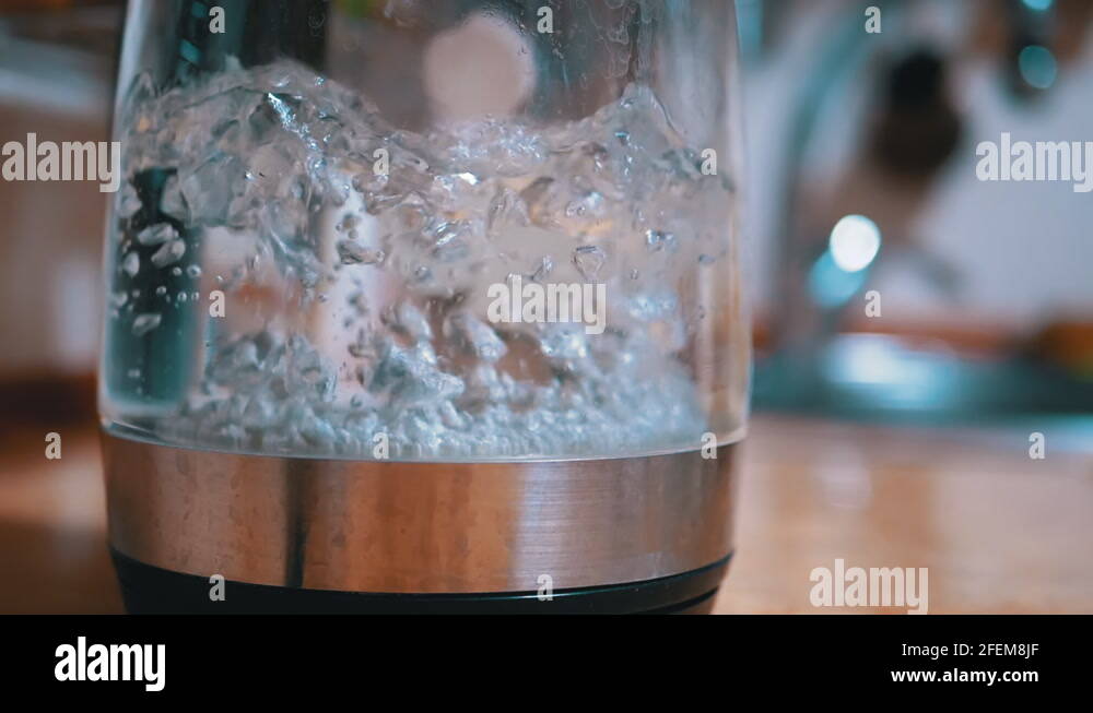 Bubbles in Water Boiling Inside Glass Electric Kettle on Backdrop ...