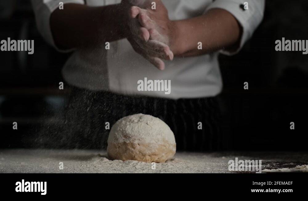bakery chef clapping flour making bread dough. Baking concept Stock ...