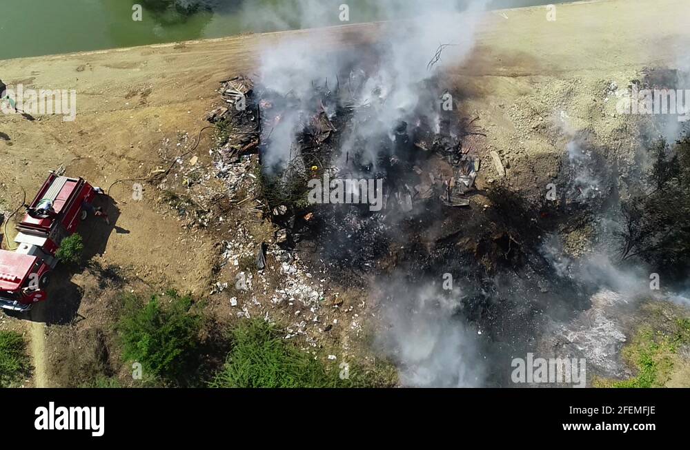 Aerial view of a structure fire, smoke rising from a building in flames ...