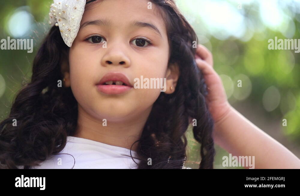 Cute little hispanic child posing to camera at park outside Stock Video ...
