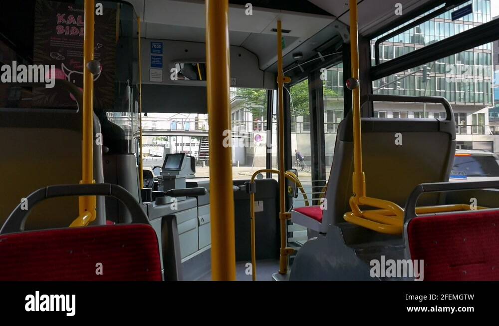 Empty bus public transport in daylight with people walking outdoors in ...