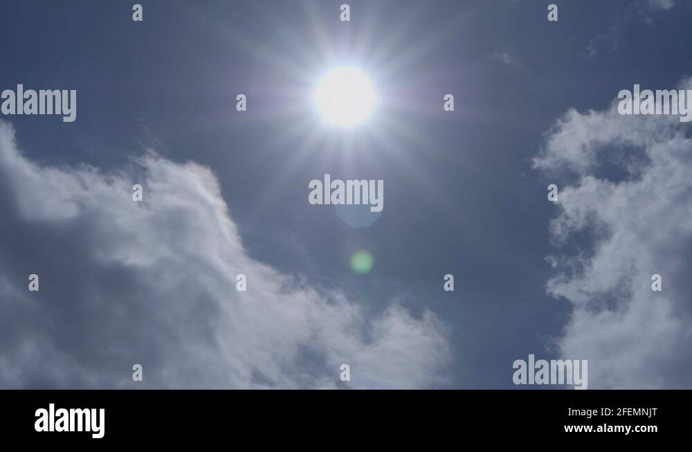Harsh sun and clouds in the sky with lens flare effect, wide shot Stock ...