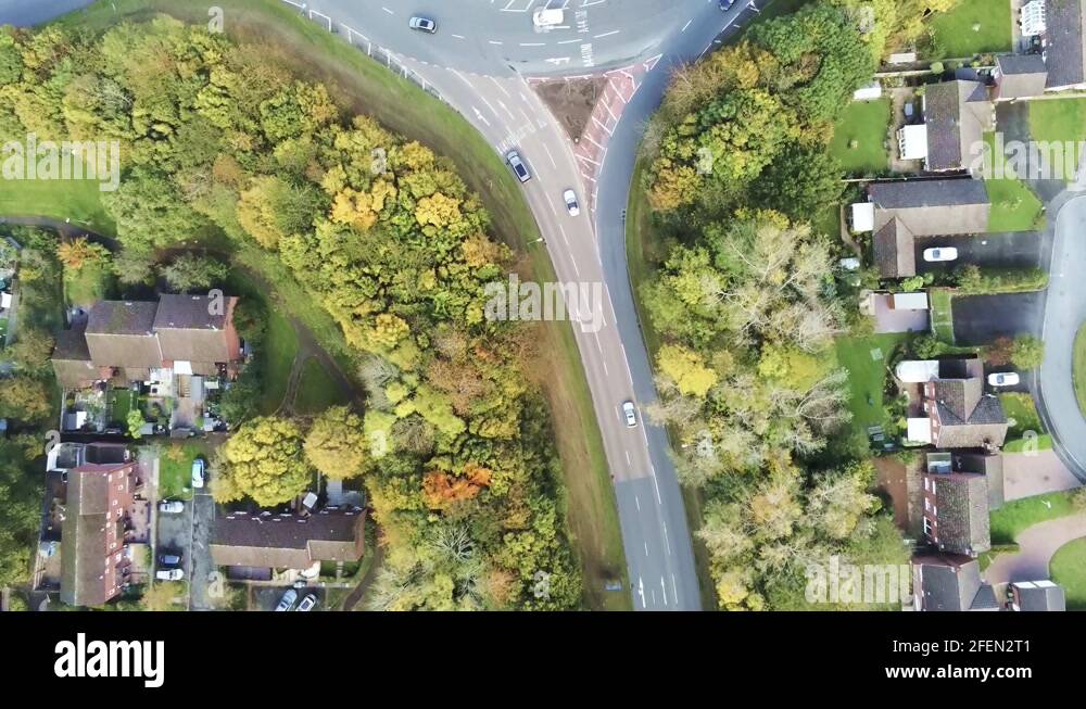 Suburb roads junction roundabout aerial view looking down over traffic ...