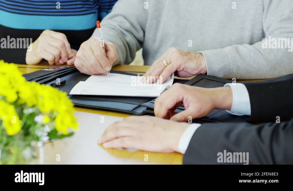 Elderly couple signing on the dotted line Stock Video Footage - Alamy