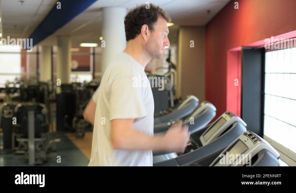 In a gym working out white man running on treadmill Stock Video Footage ...