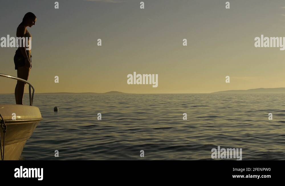 Girl jumping into the sea from a boat Stock Video Footage - Alamy