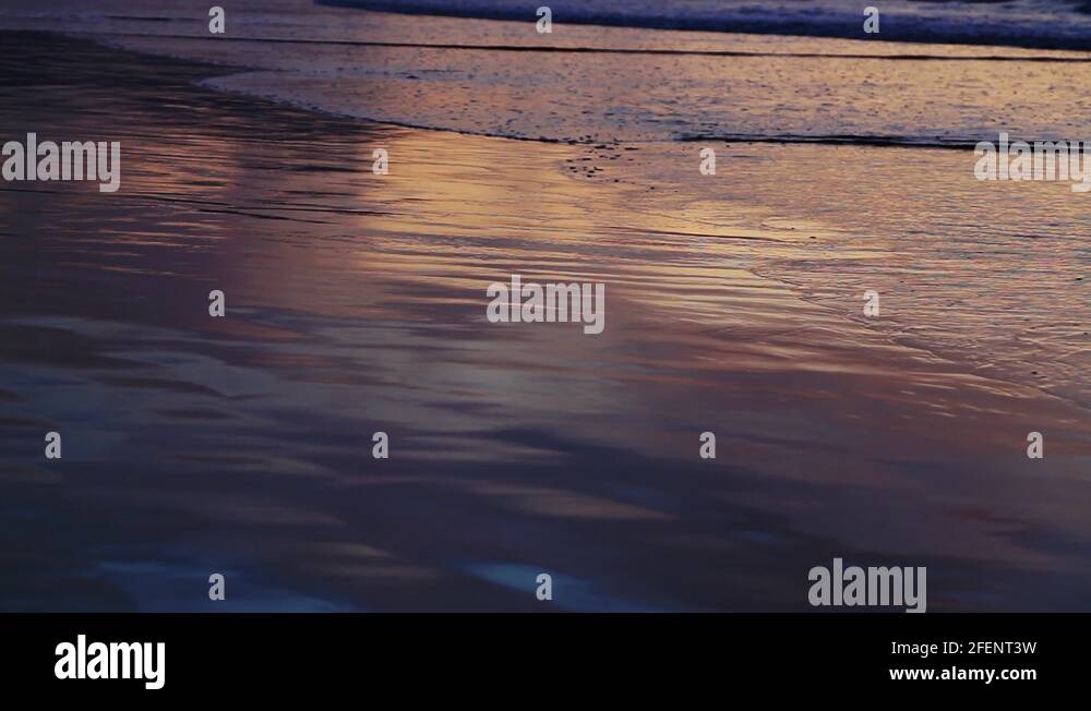 Tide on beach at spectacular sunset Stock Video Footage - Alamy