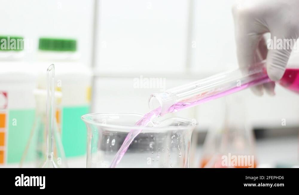 Scientist dropping liquid into vial Stock Video Footage - Alamy