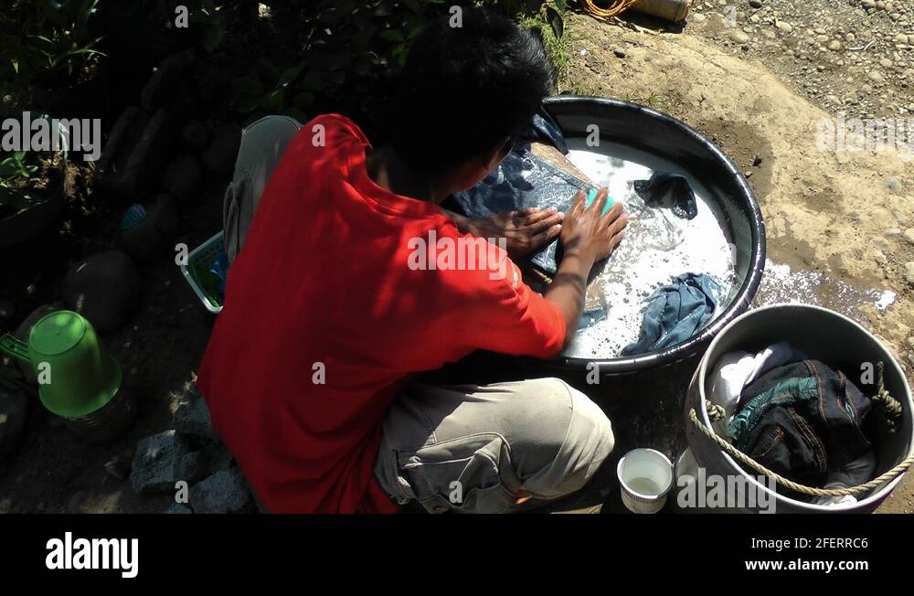 Filipino man handwashing clothes Stock Video Footage - Alamy