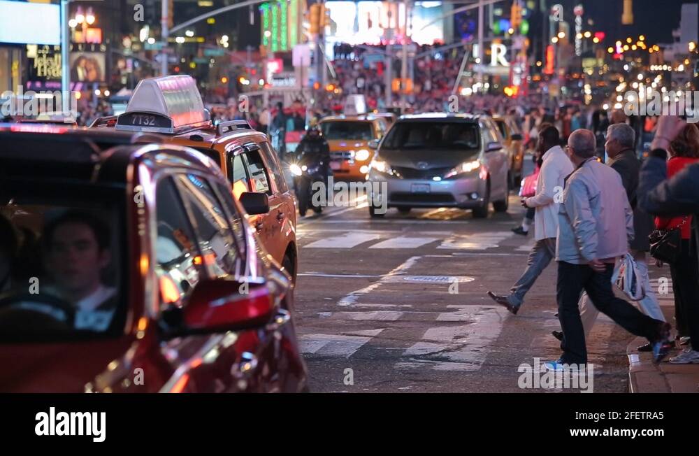 Crowd of people walking at night in New York City Times Square Stock ...