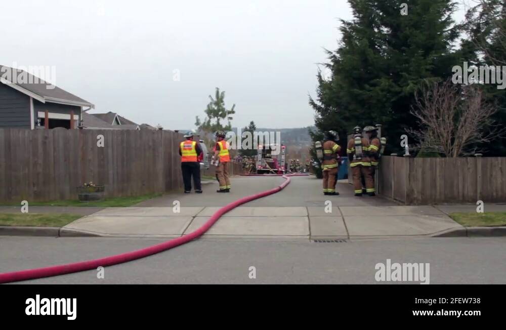 Firefighters, fire hose and fire engine in alley Stock Video Footage ...
