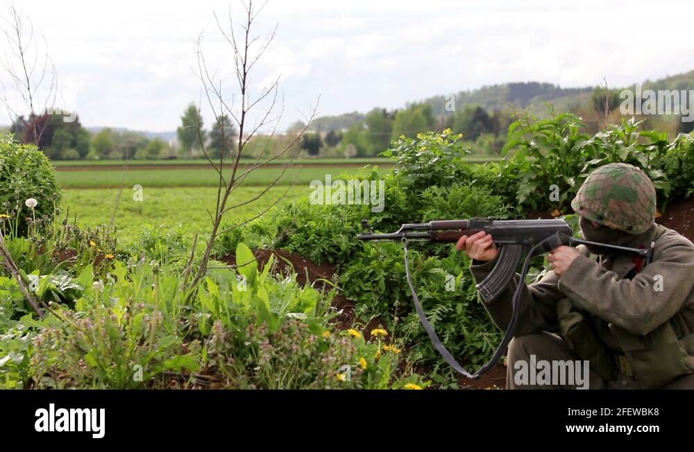 Soldier in trench reloading AK 47 Stock Video Footage - Alamy
