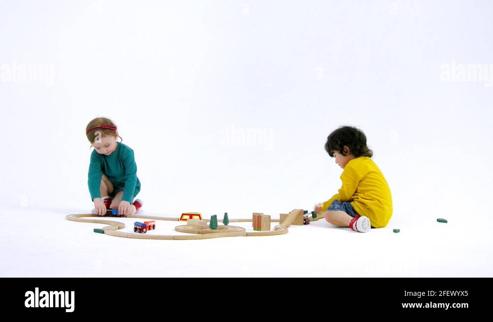 Two little kids playing on the ground isolated on white Stock Video ...