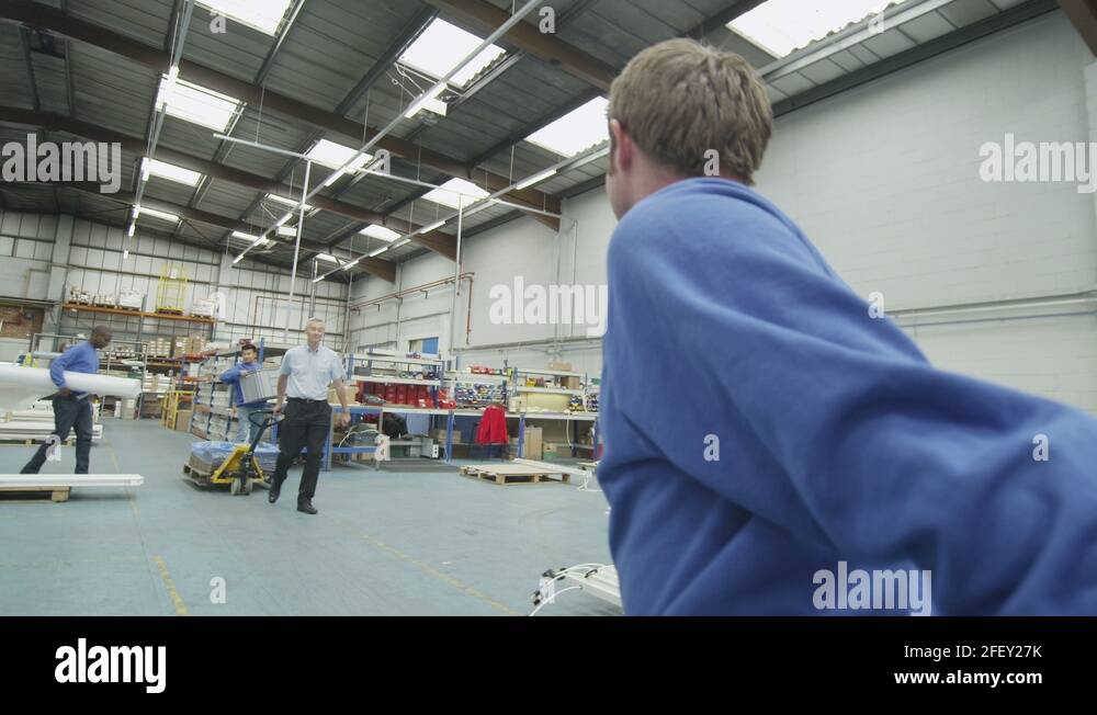 Team of warehouse workers moving around pallets of goods Stock Video ...