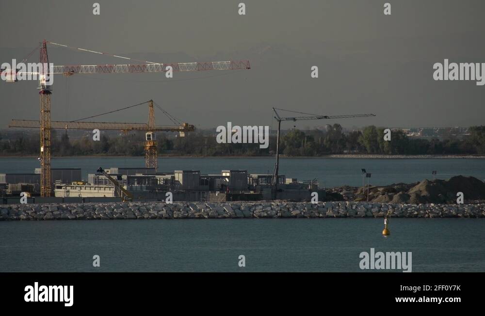 Venice MOSE project, construction cranes, Lido Lagoon medium shot ...
