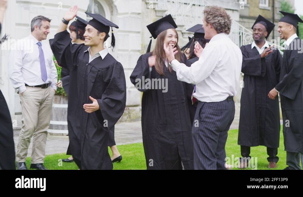 Happy student friends hugging and congratulating each other on ...